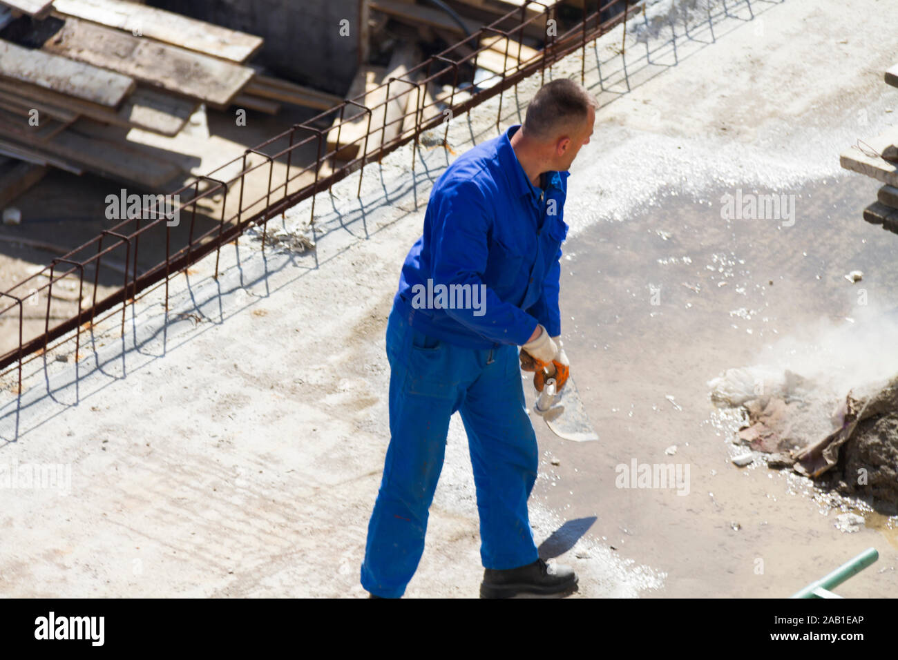 Photo of the Worker works with a shovel, cleaning rubble Stock Photo ...