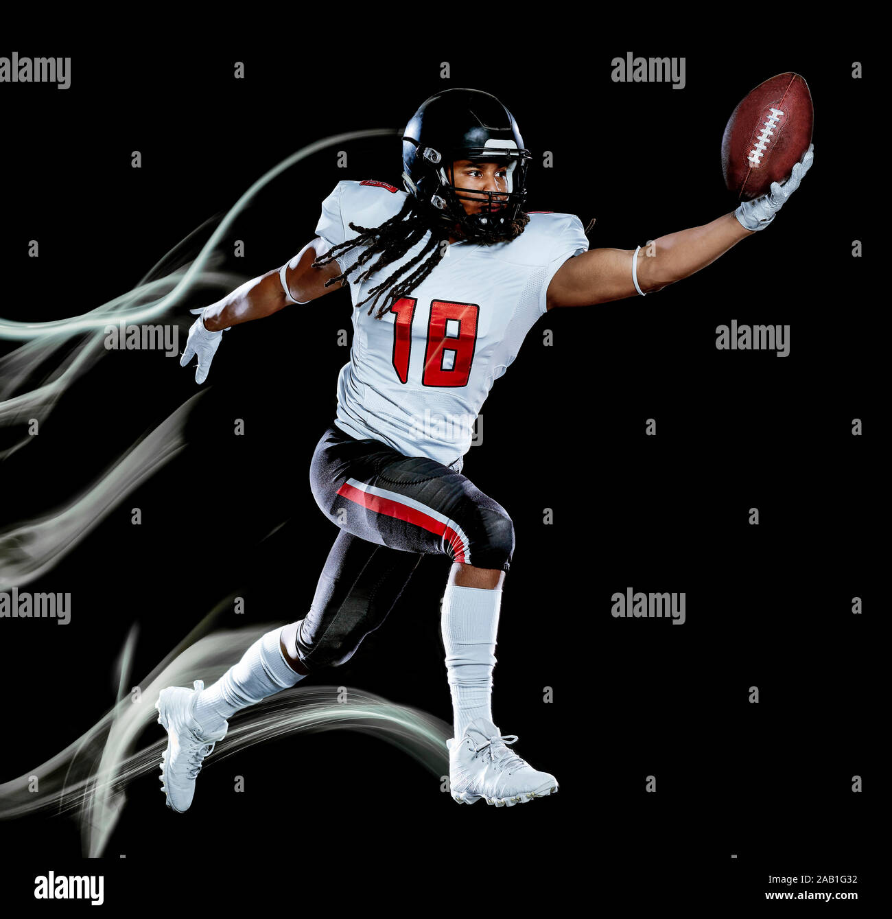 one african american football player man studio shot isolated on black ...