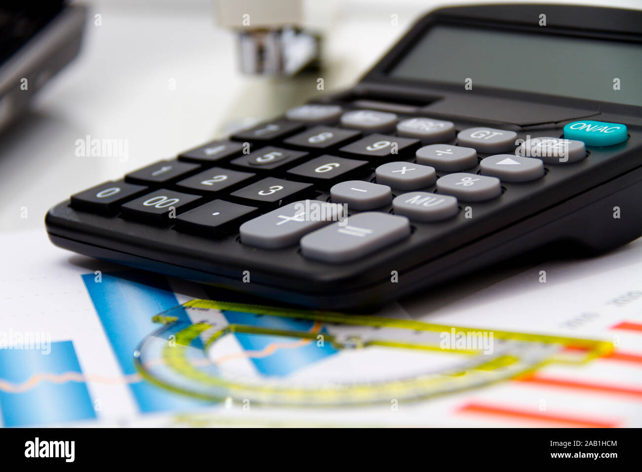 Photo of the Analyzing business investment charts with calculator and ...