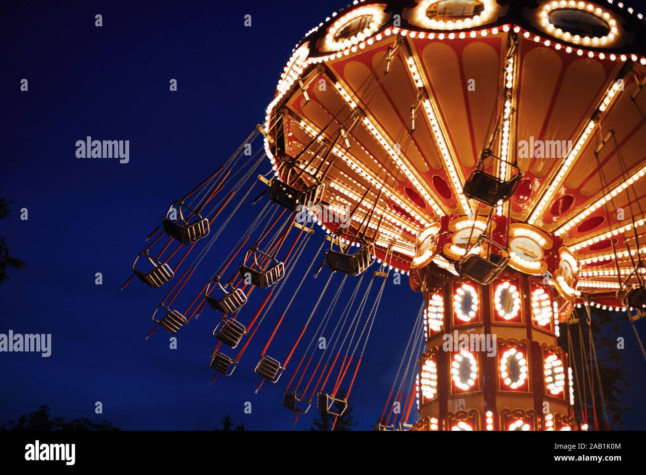 Carousel Merry-go-round in amusement park at night city Stock Photo - Alamy