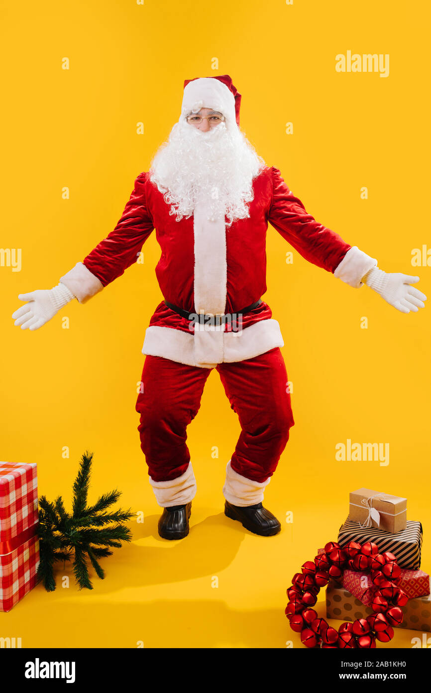 Happy dancing Santa Claus squating with hands and knees apart, like ...