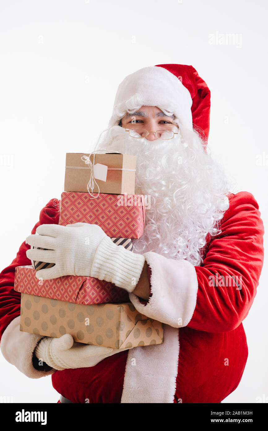 Joyful smiling Santa Claus with hands full of presents for christmas ...