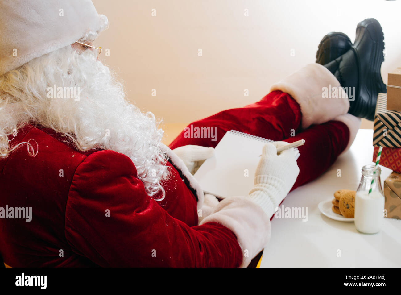 Santa Claus working behind a desk, arranging his affairs, writing on a ...