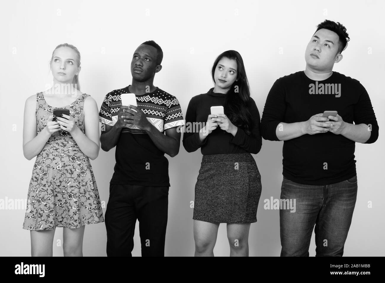 Studio shot of diverse group of multi ethnic friends thinking while ...
