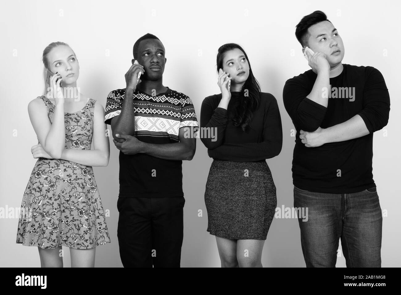 Studio shot of diverse group of multi ethnic friends thinking while ...