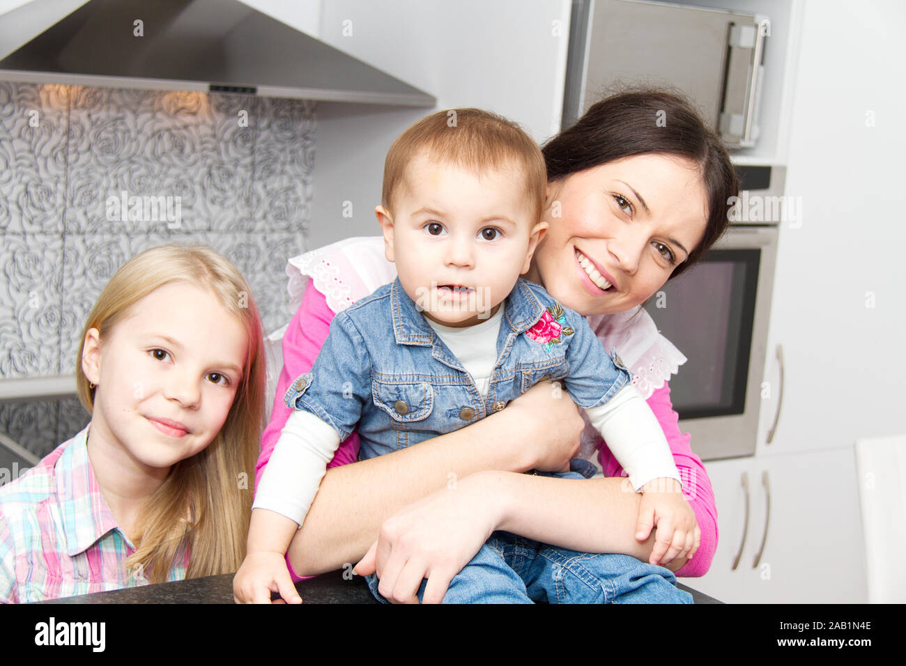 Happy sisters cooking in the kitchen Stock Photo - Alamy