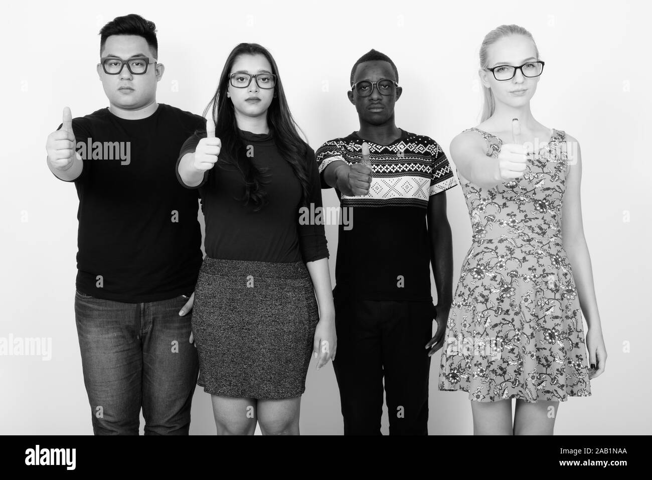 Studio shot of diverse group of multi ethnic friends giving thumb up ...