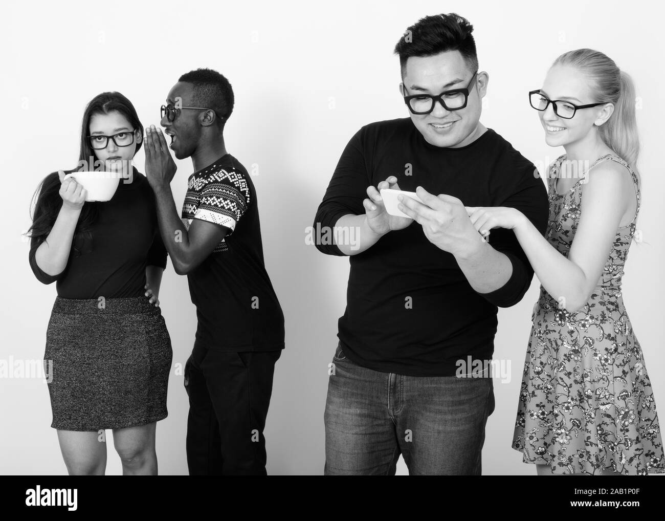 Happy diverse group of multi ethnic friends using mobile phone together ...