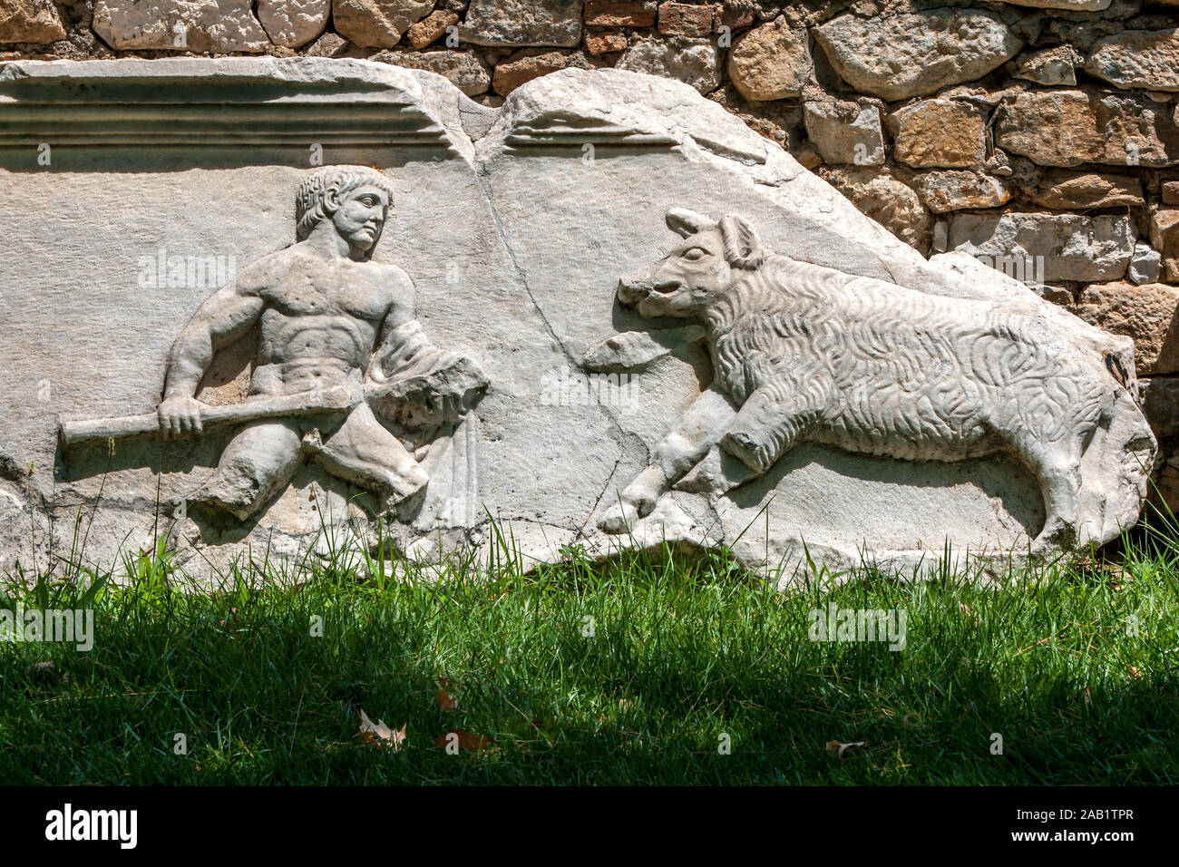 A section of a stone carved tomb displaying the relief detail of a man ...