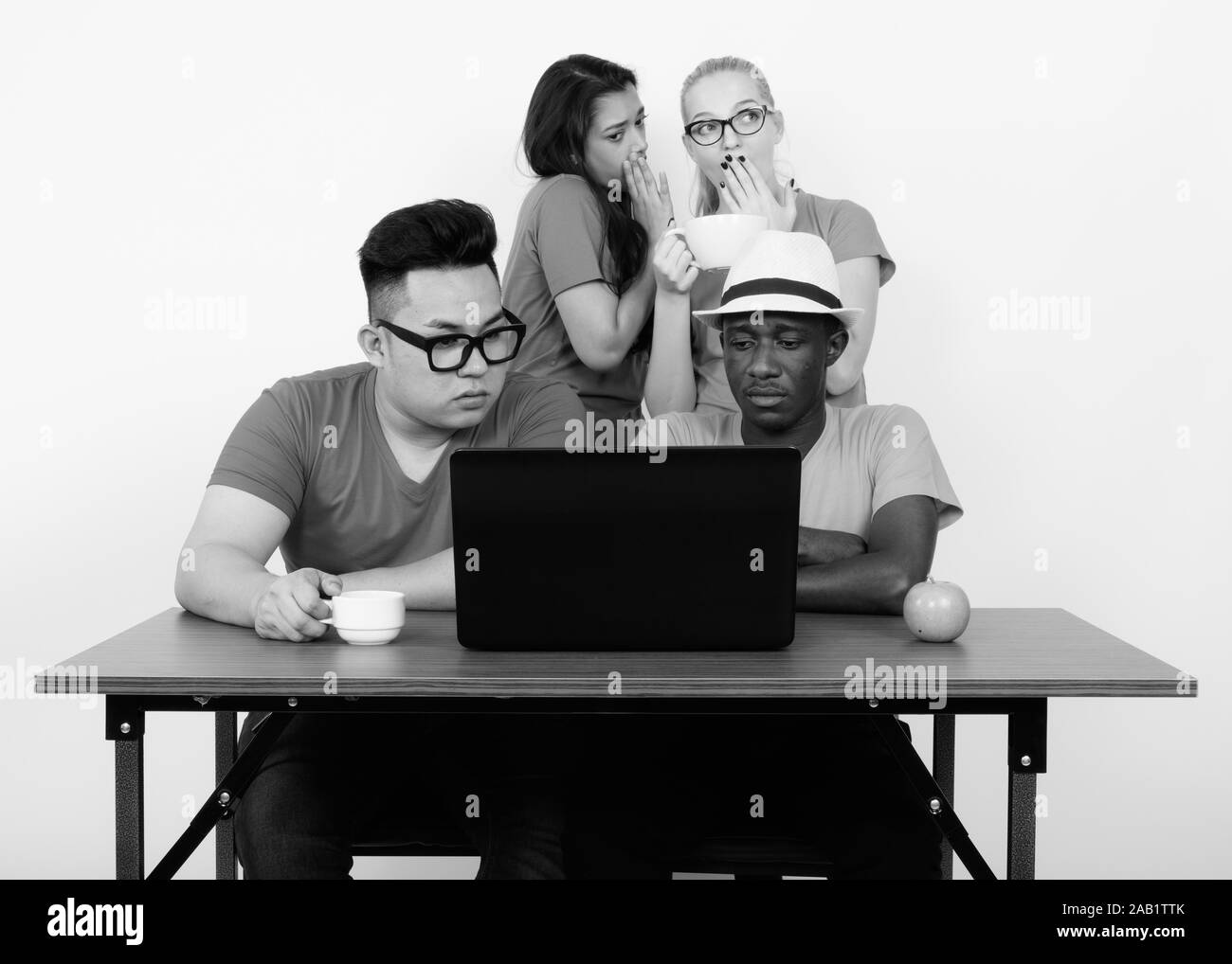 Diverse group of multi ethnic friends using laptop together with ...