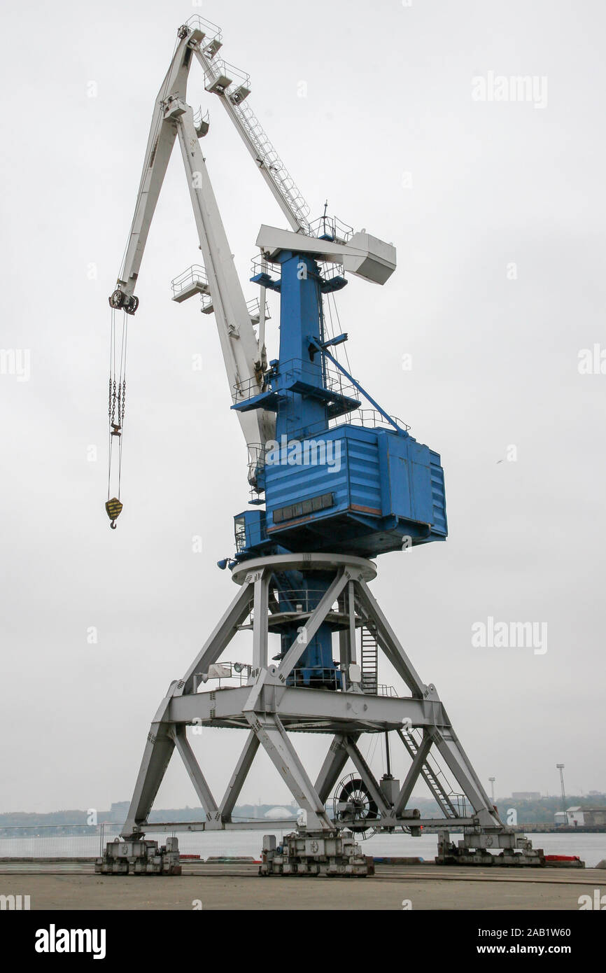 A large high port crane on rails against a gray sky. Powerful system ...
