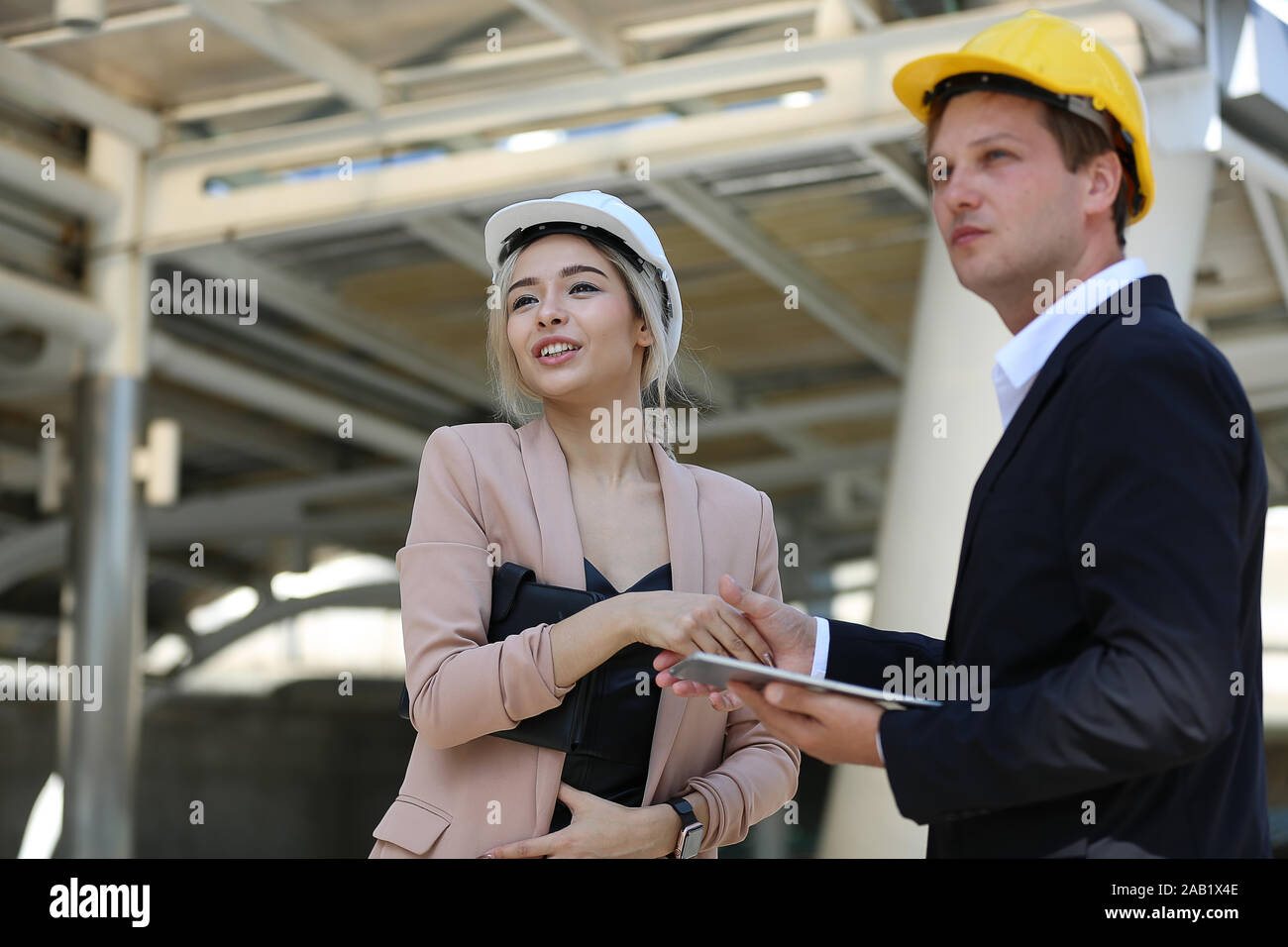 The engineer and business people hand high five against building. The ...