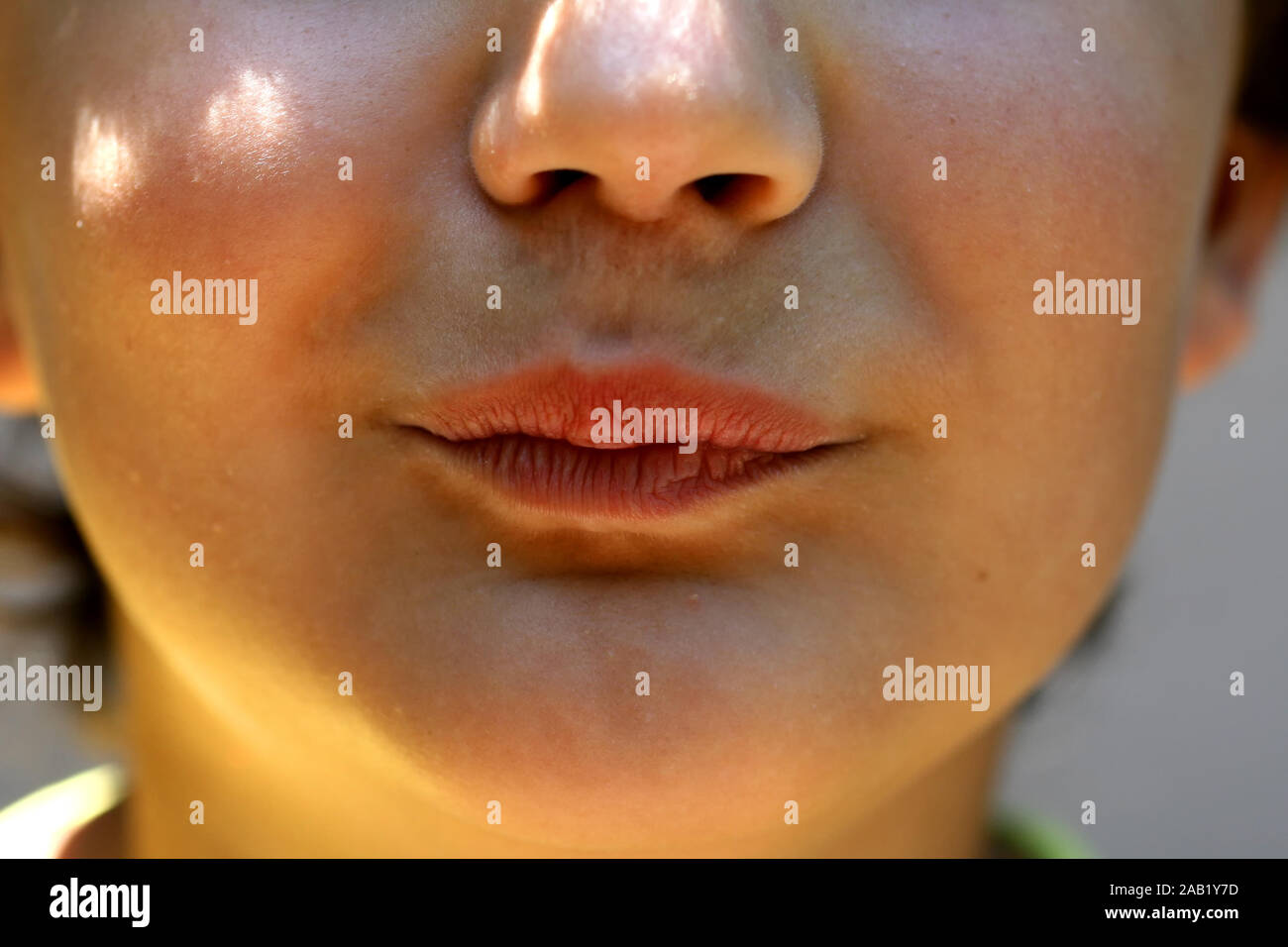 Smiling child. Compressed lips Stock Photo - Alamy