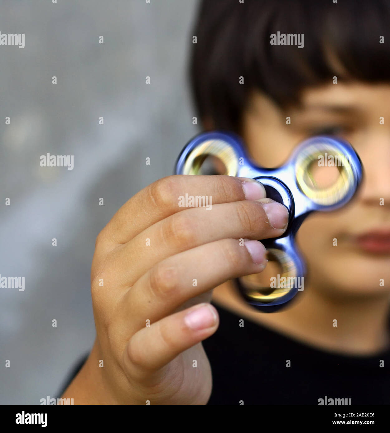 Hand spinner or fidgeting spinner rotating on child's hand Stock Photo ...
