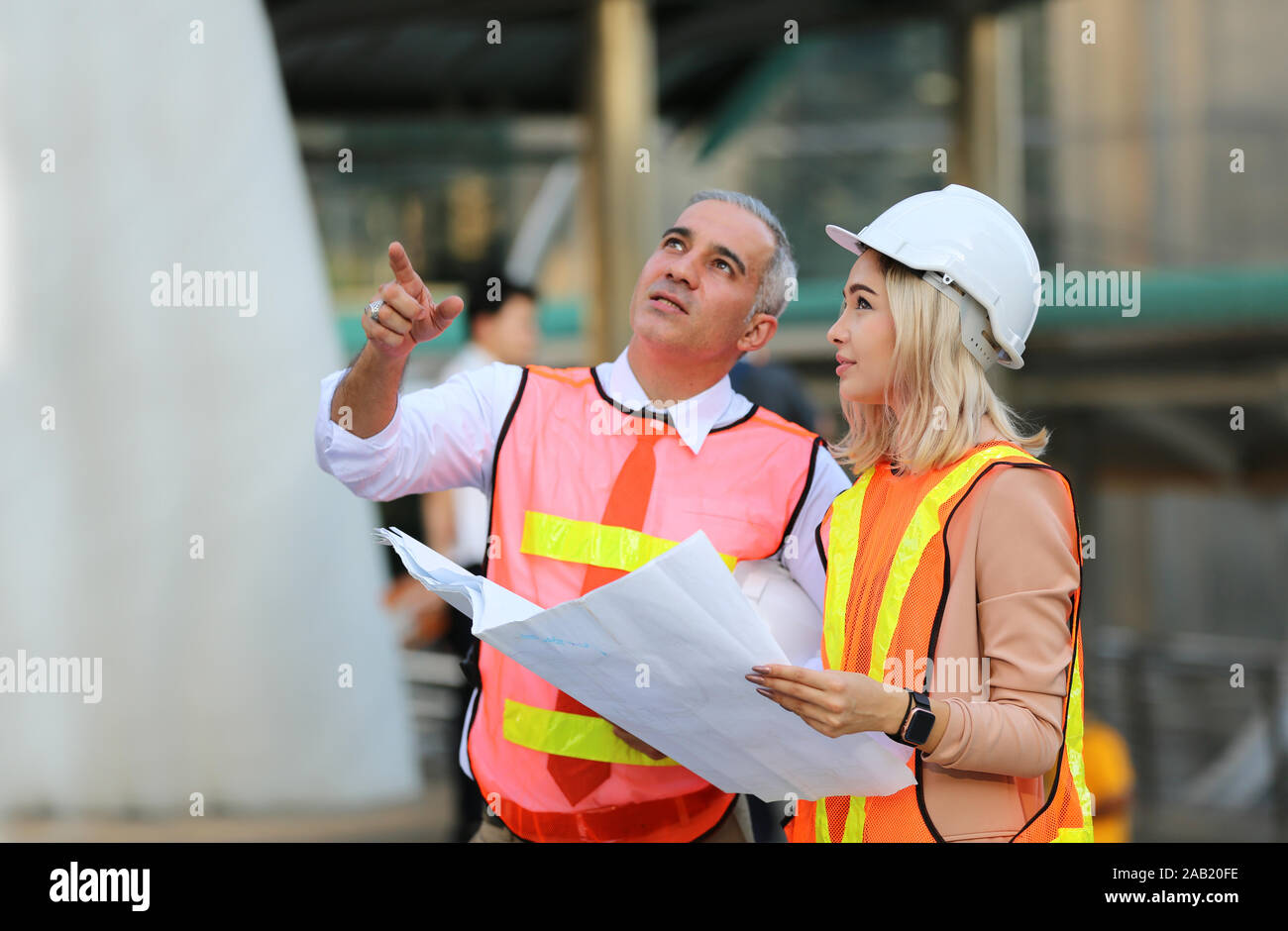 The engineer and business people hand high five against building. The ...