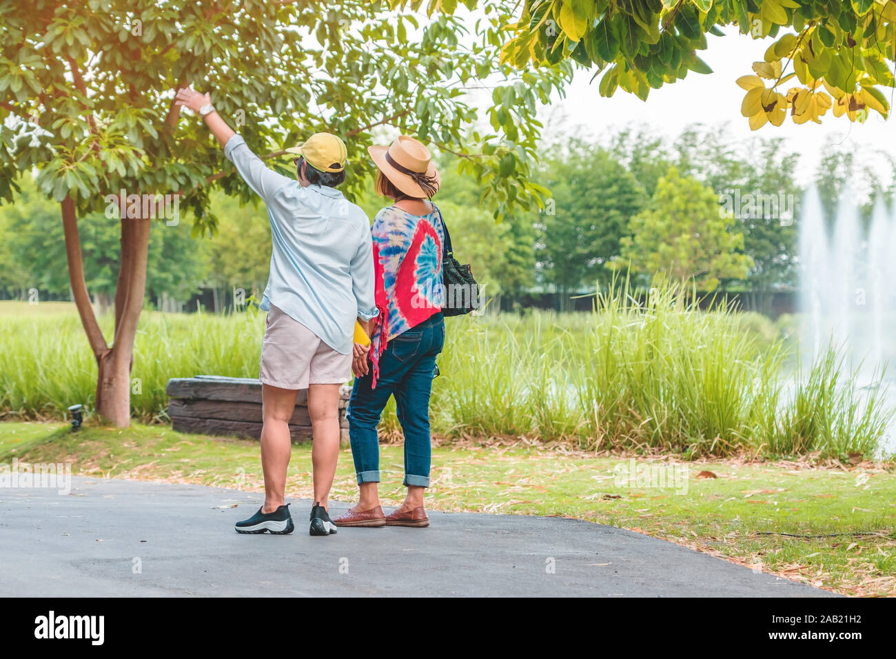 Back view of happiness female friends walking together beside the ...