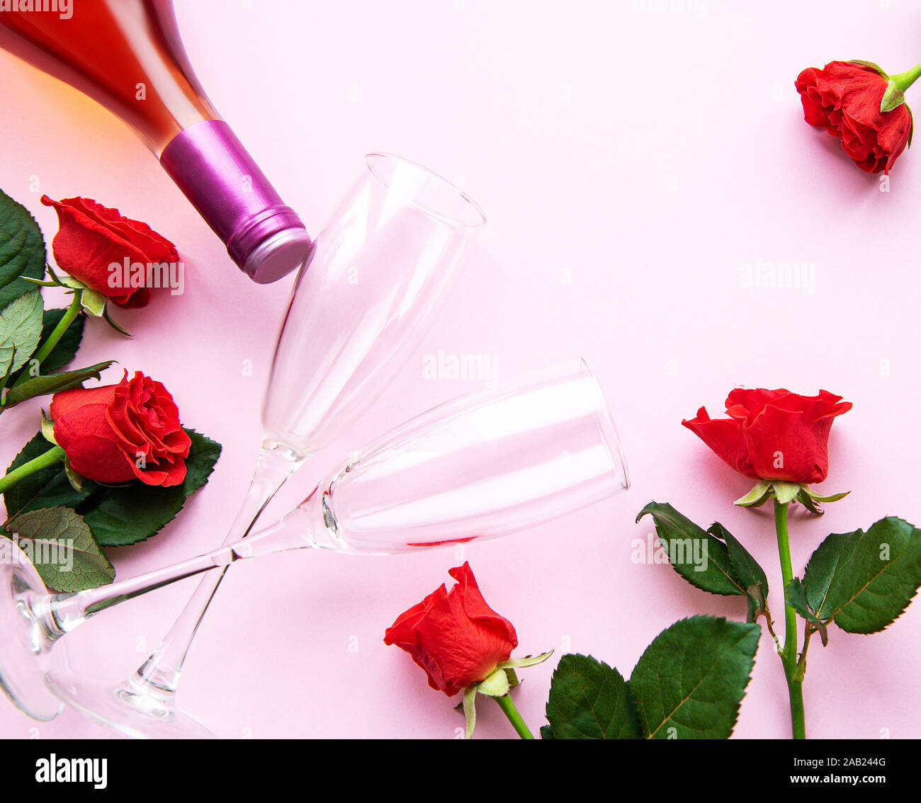 Valentines day greeting card. Red roses, wine and glasses for wine on a ...