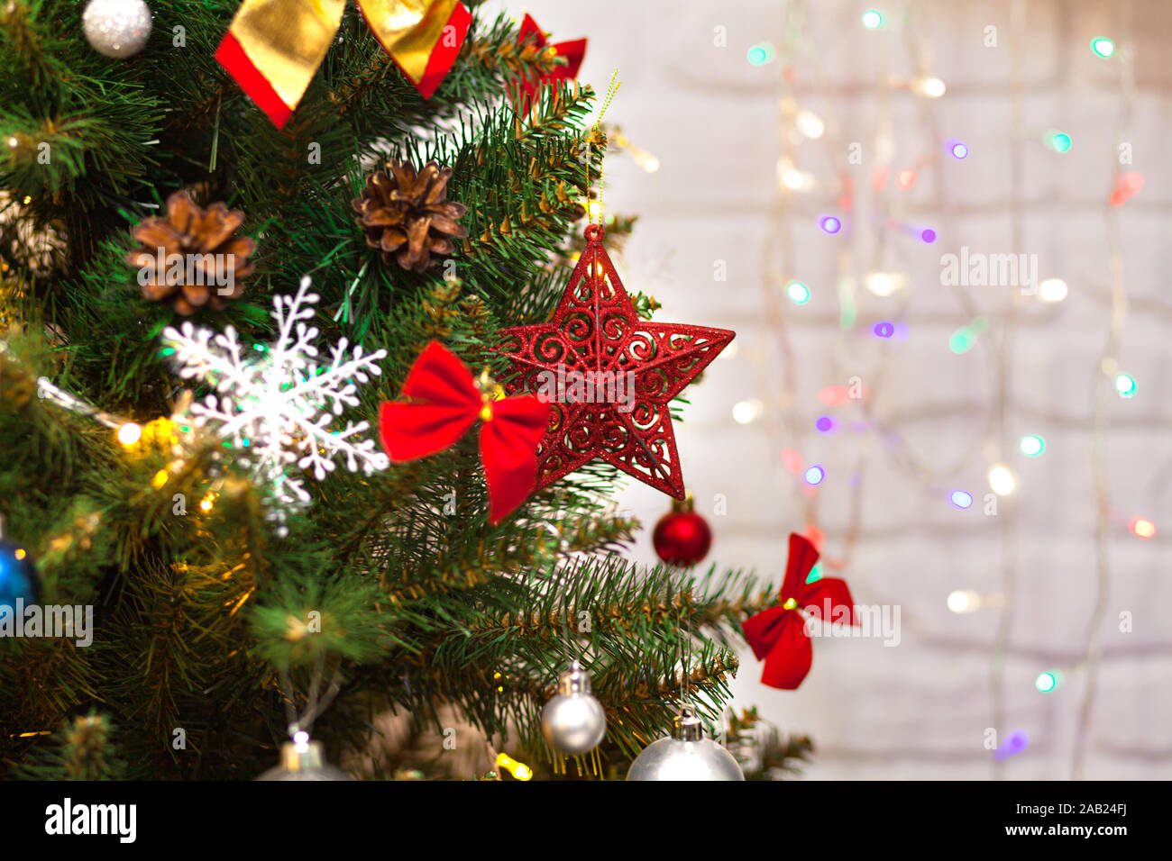 Beautiful green Christmas tree decorated with balls, big red star and ...