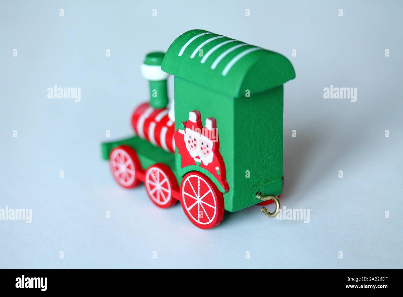 Green festive wooden train locomotive or railway engine on white ...