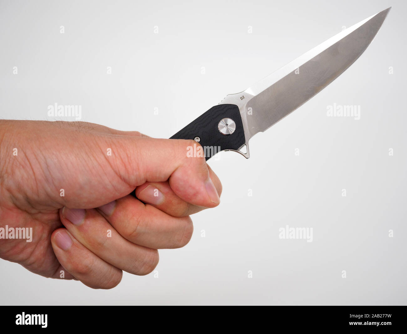 Hand holds pocket / folding / utility / knife isolated on white ...