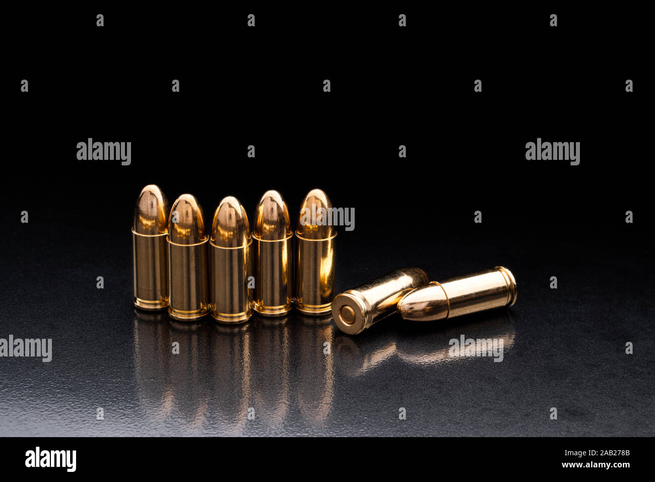 Bullet isolated on black background with reflexion. Rifle bullets close ...