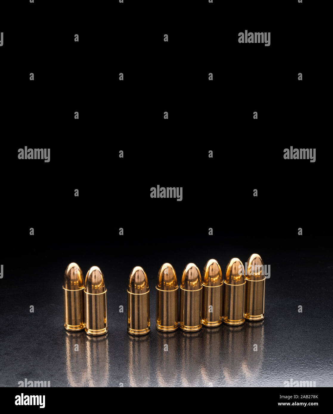 Bullet isolated on black background with reflexion. Rifle bullets close ...