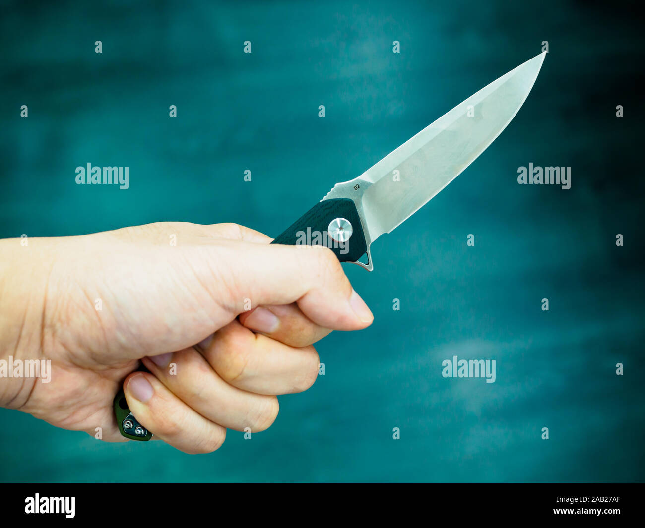 Hand holds pocket / folding / utility / knife on dark background Stock ...