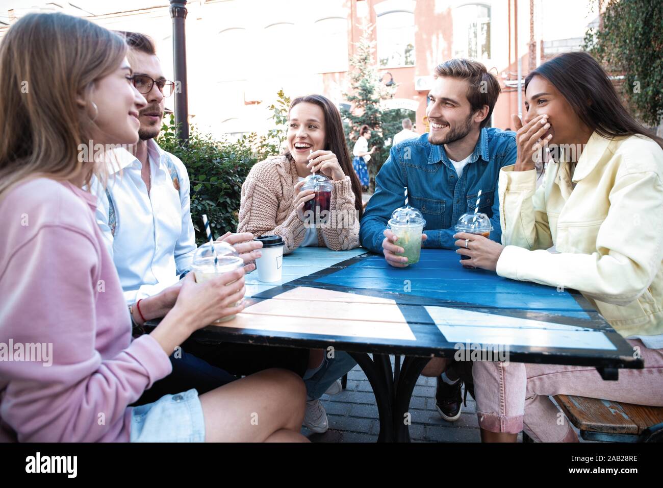 Group Of Friends Drinking Cocktails At Outdoor Bar Stock Photo - Alamy