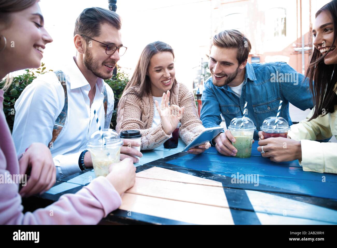 Group Of Friends Drinking Cocktails At Outdoor Bar Stock Photo - Alamy