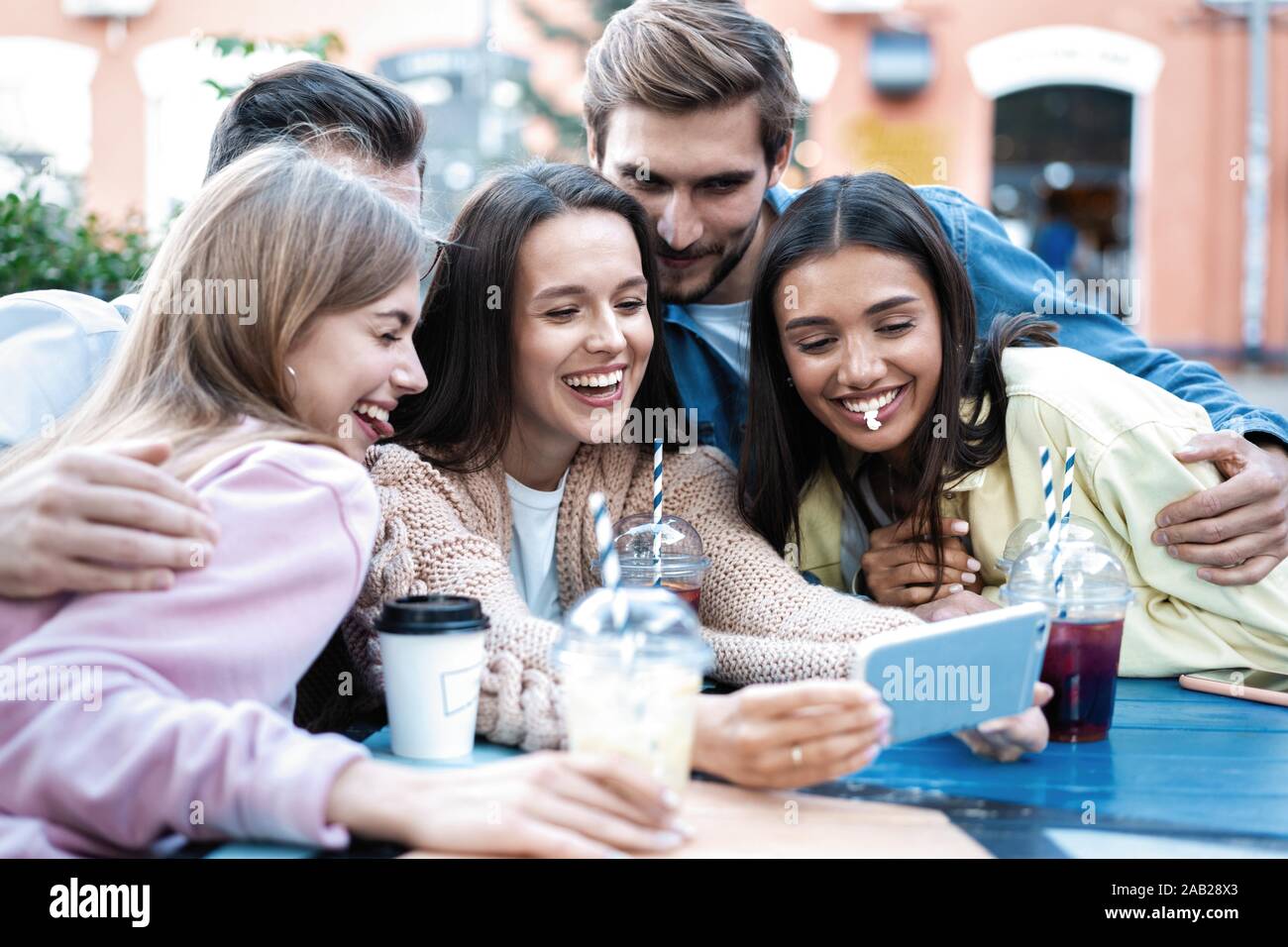 Group Of Friends Drinking Cocktails At Outdoor Bar Stock Photo - Alamy