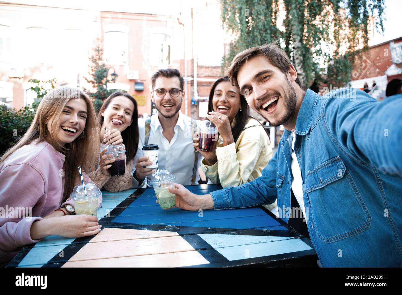 Group Of Friends Drinking Cocktails At Outdoor Bar Stock Photo - Alamy