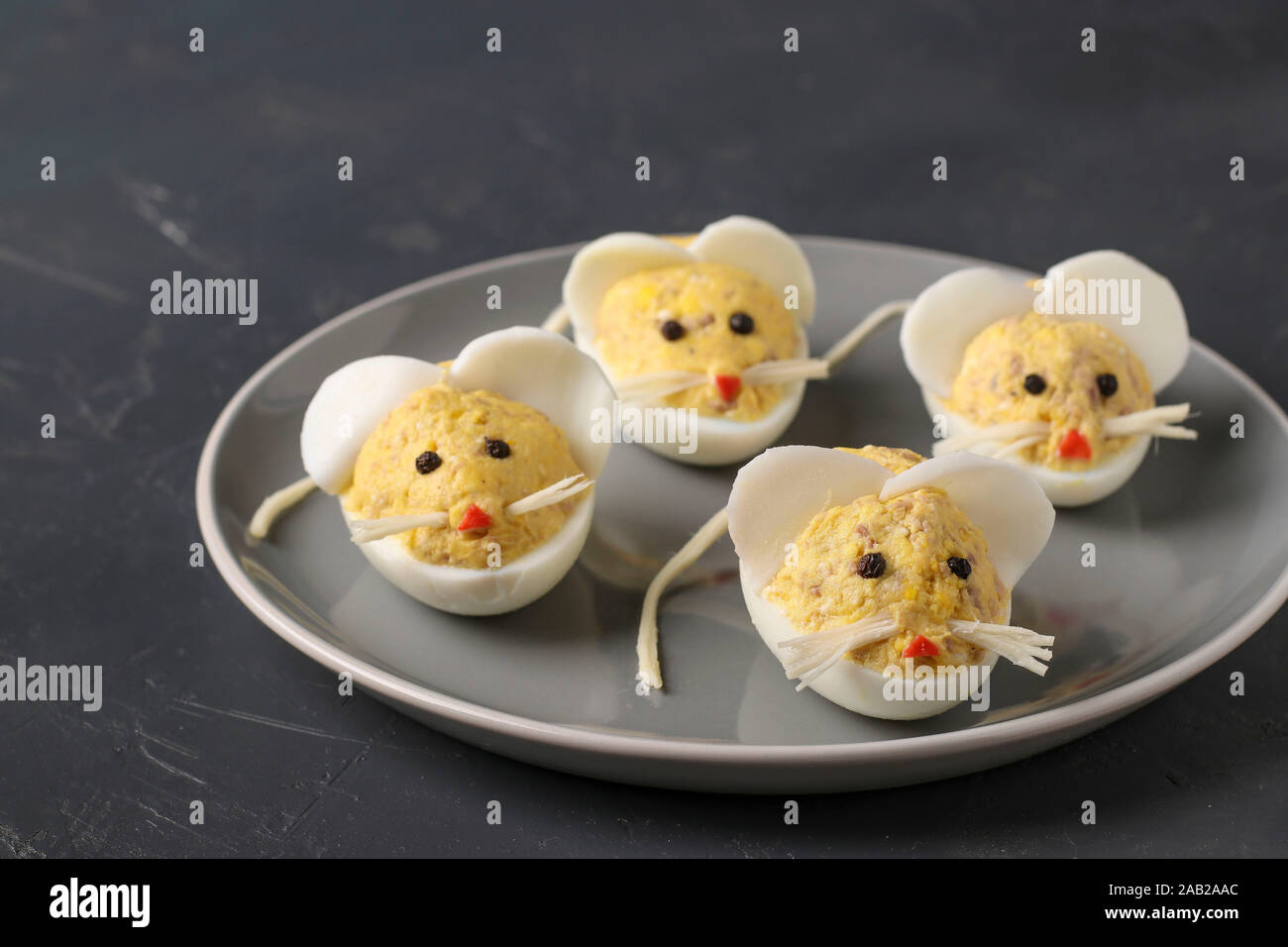 Festive snack Mice for 2020 made of stuffed eggs with cod liver on a ...