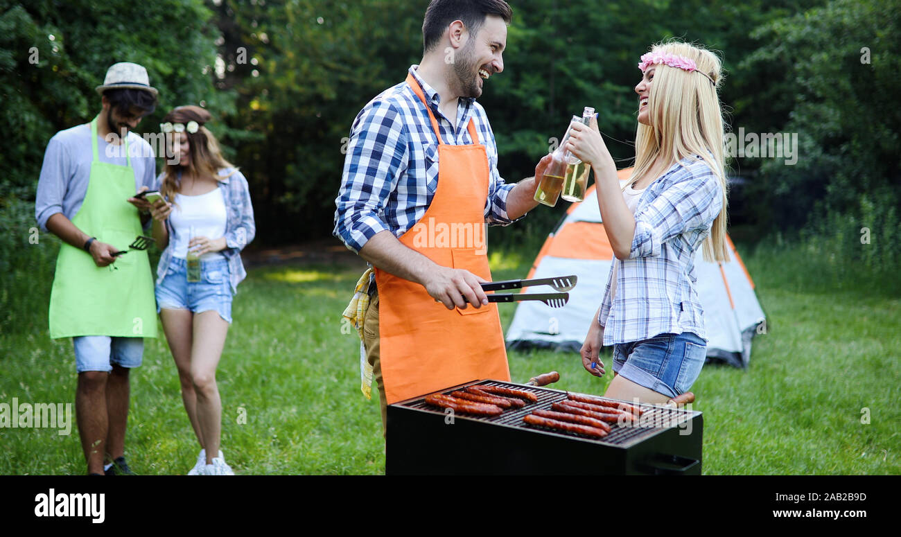 Group of friends making barbecue Stock Photo - Alamy