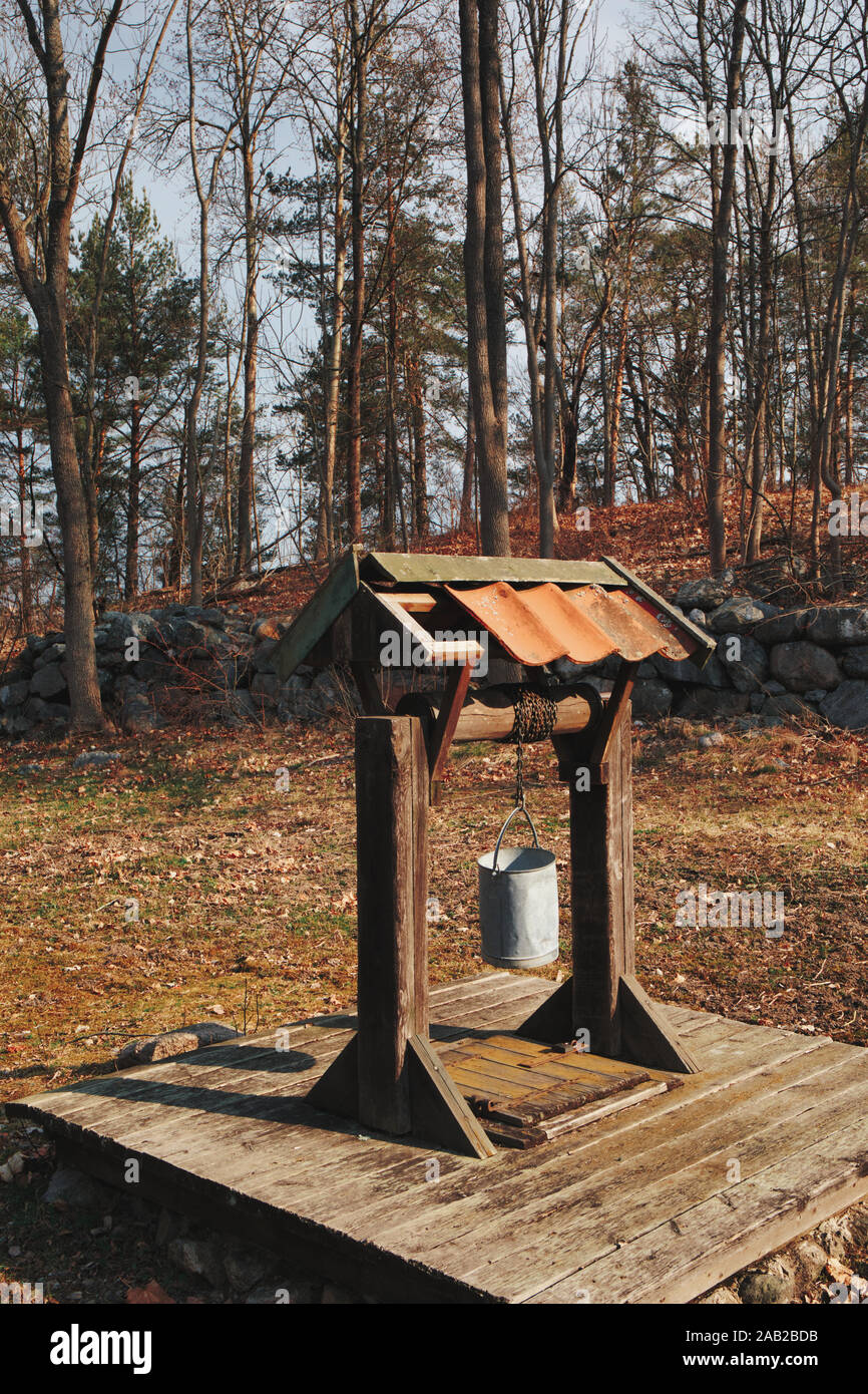 Traditional wooden draw well with metal bucket, Fjaderholmarna island ...