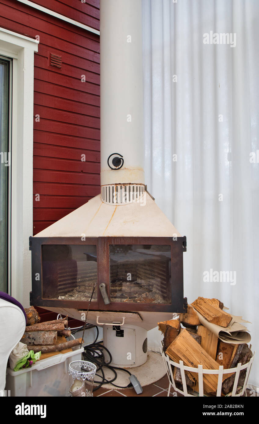 Wood burning stove and firewood in summer lounge of typical Swedish ...
