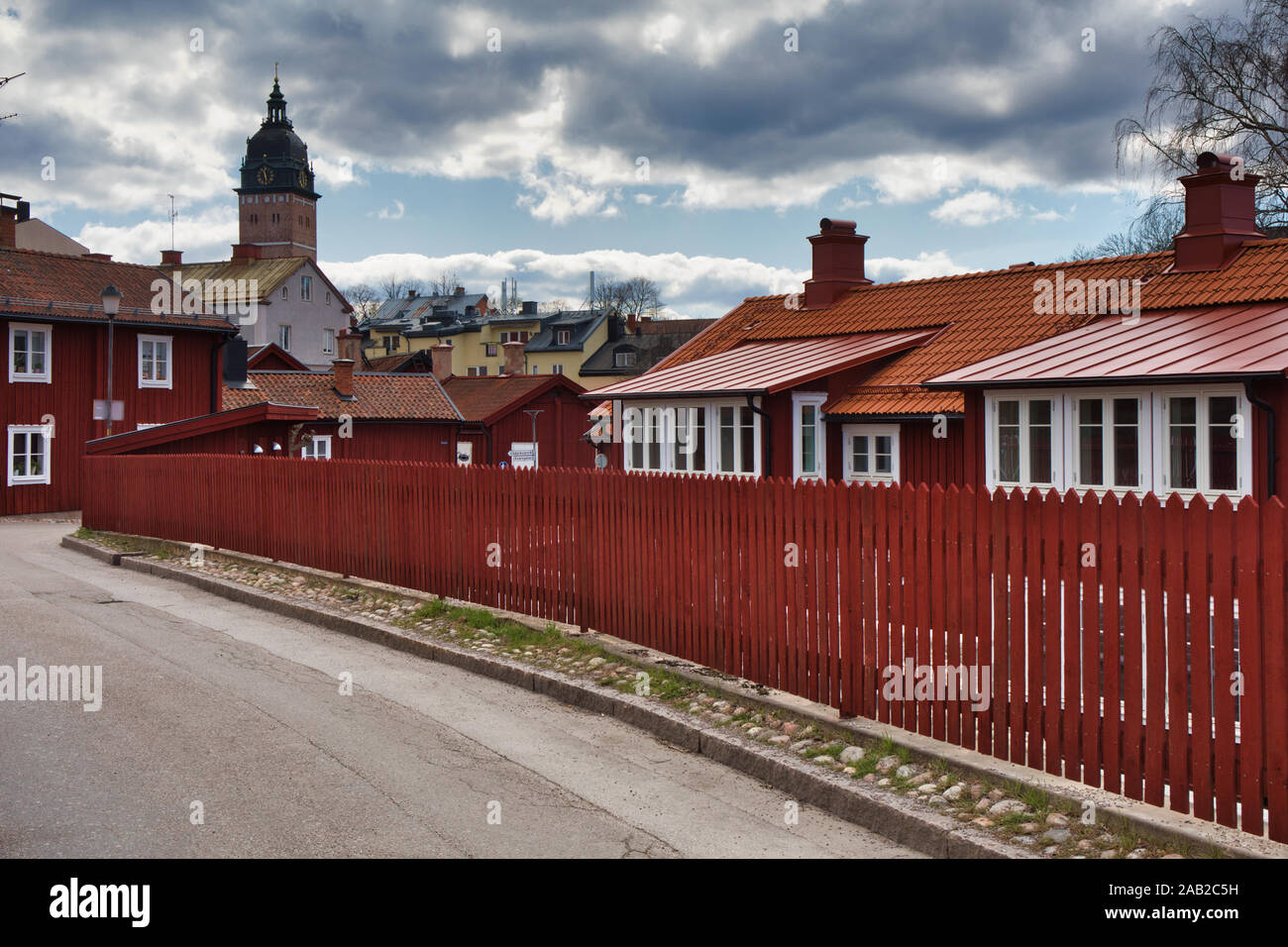 Falu red timber buildings and Strangnas Cathedral tower, Strangnas ...