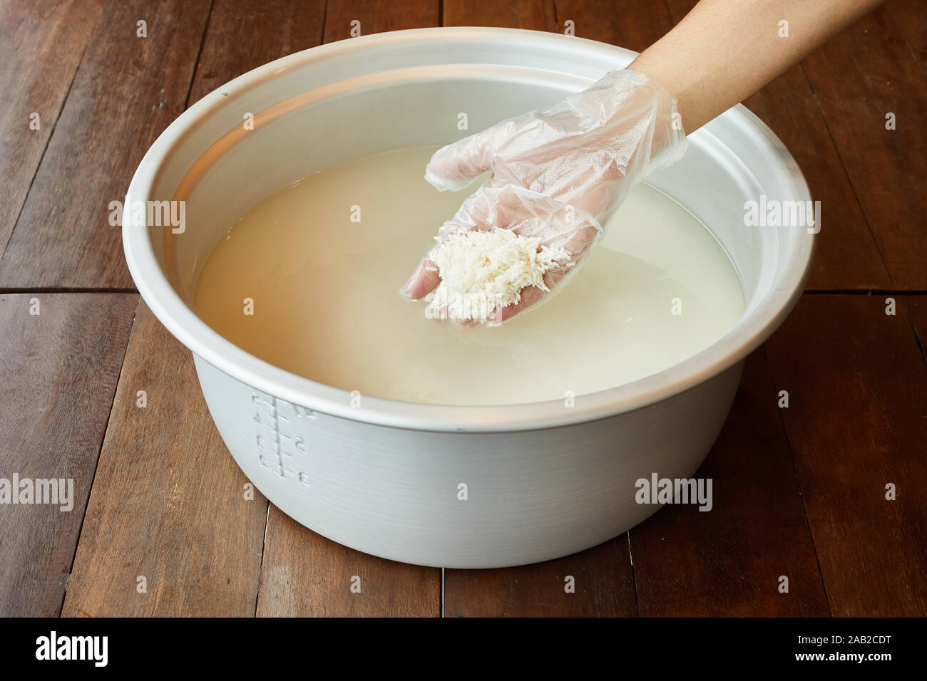 Hands dropping rice grain aluminum pot,Cook rice concept Stock Photo ...