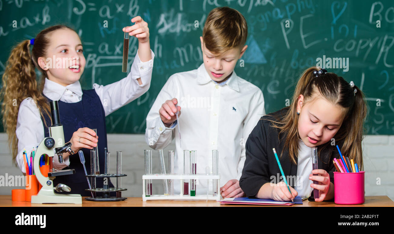 School laboratory. Girls and boy student conduct school experiment with ...