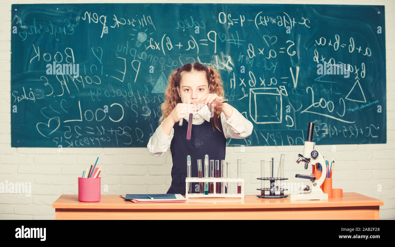 School laboratory. Girl smart student conduct school experiment. School ...