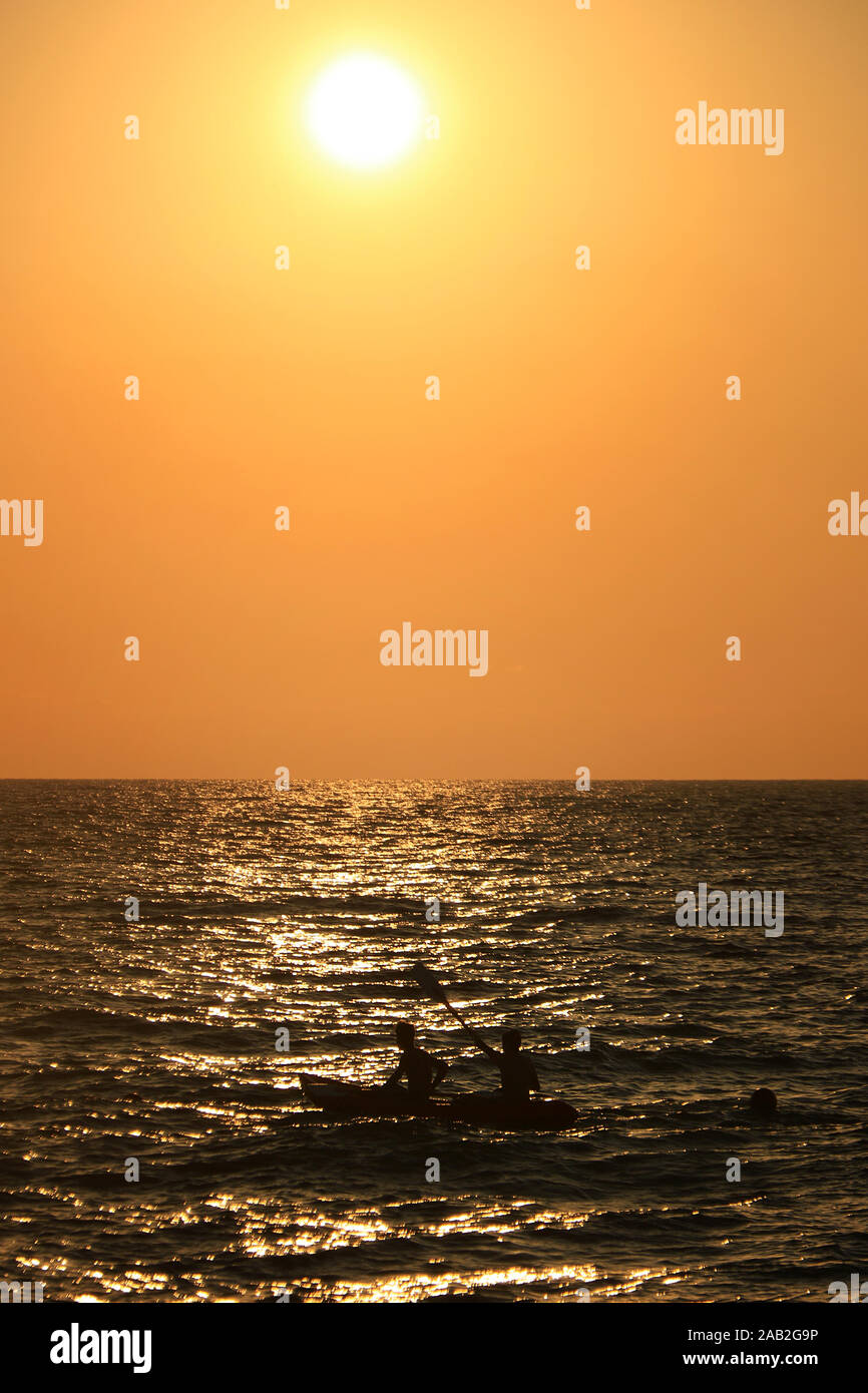 Young men rowing boat hi-res stock photography and images - Alamy