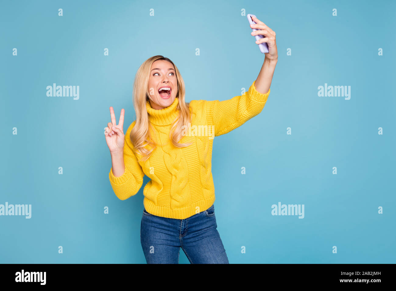Photo Of Amazing Blond Lady Holding Telephone Hands Showing V Sign