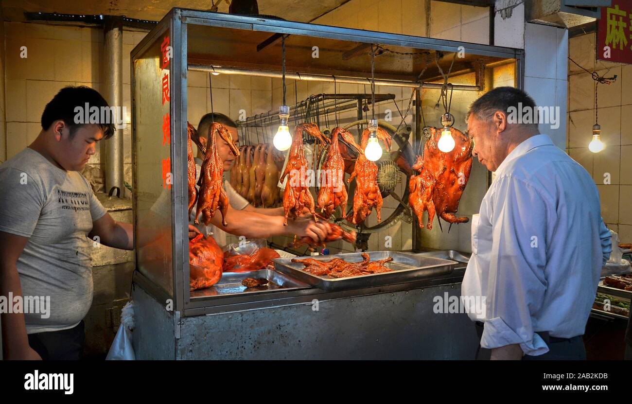 Roasted duck stall in a food market at Kunming city, Yunnan province ...