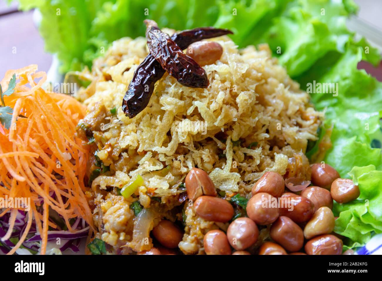 Yam Naem Khao Thot is Spicy Salad of Curried Rice Croquettes, Fermented ...
