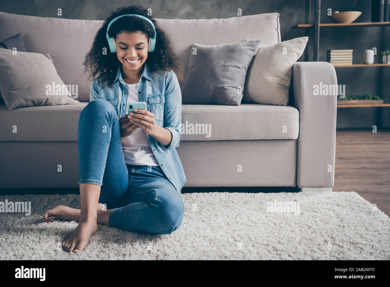 Photo of beautiful dark skin wavy lady homey mood holding telephone ...