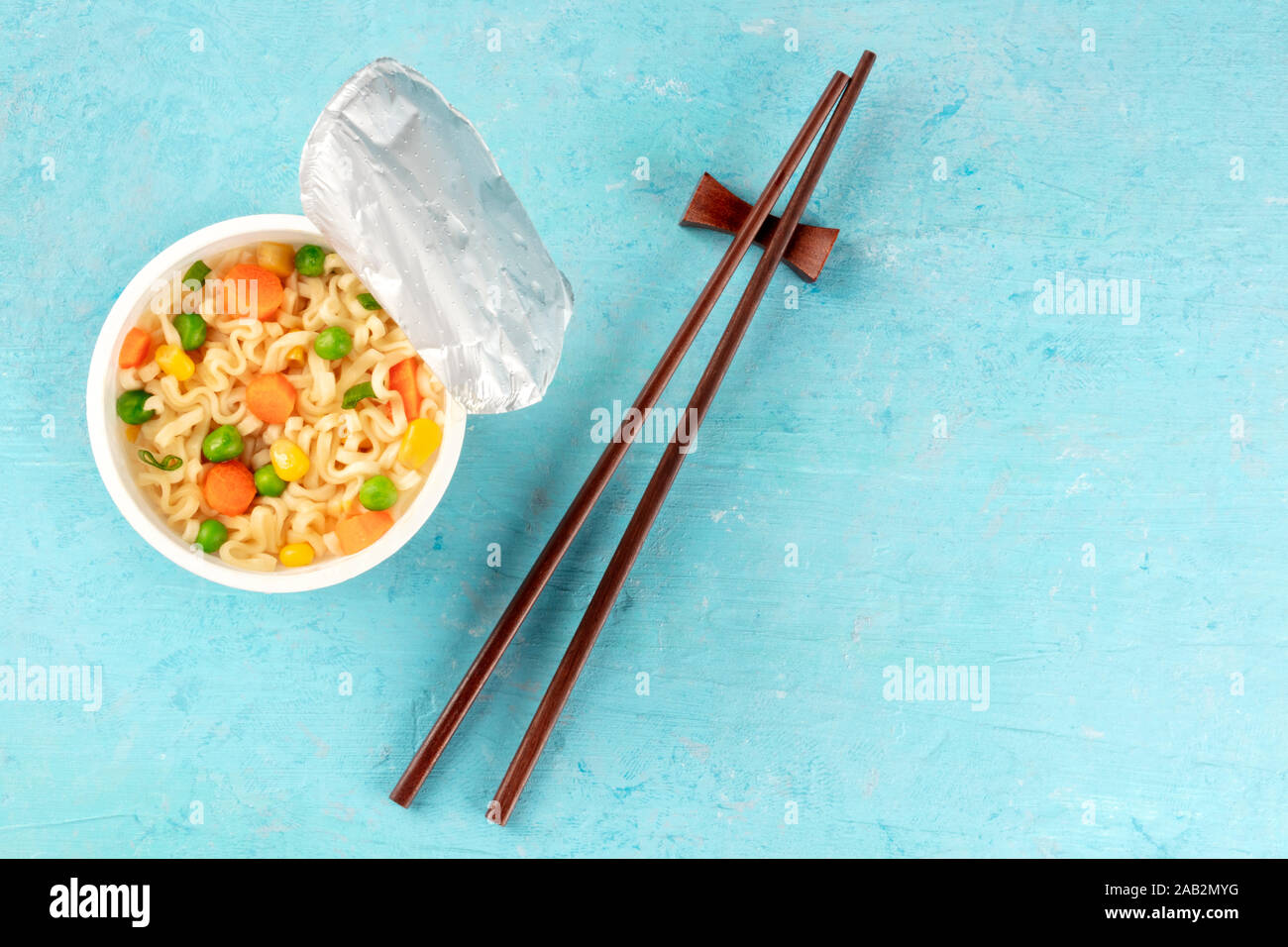 Ramen cup, instant noodles in a plastic cup, top shot with chopsticks ...
