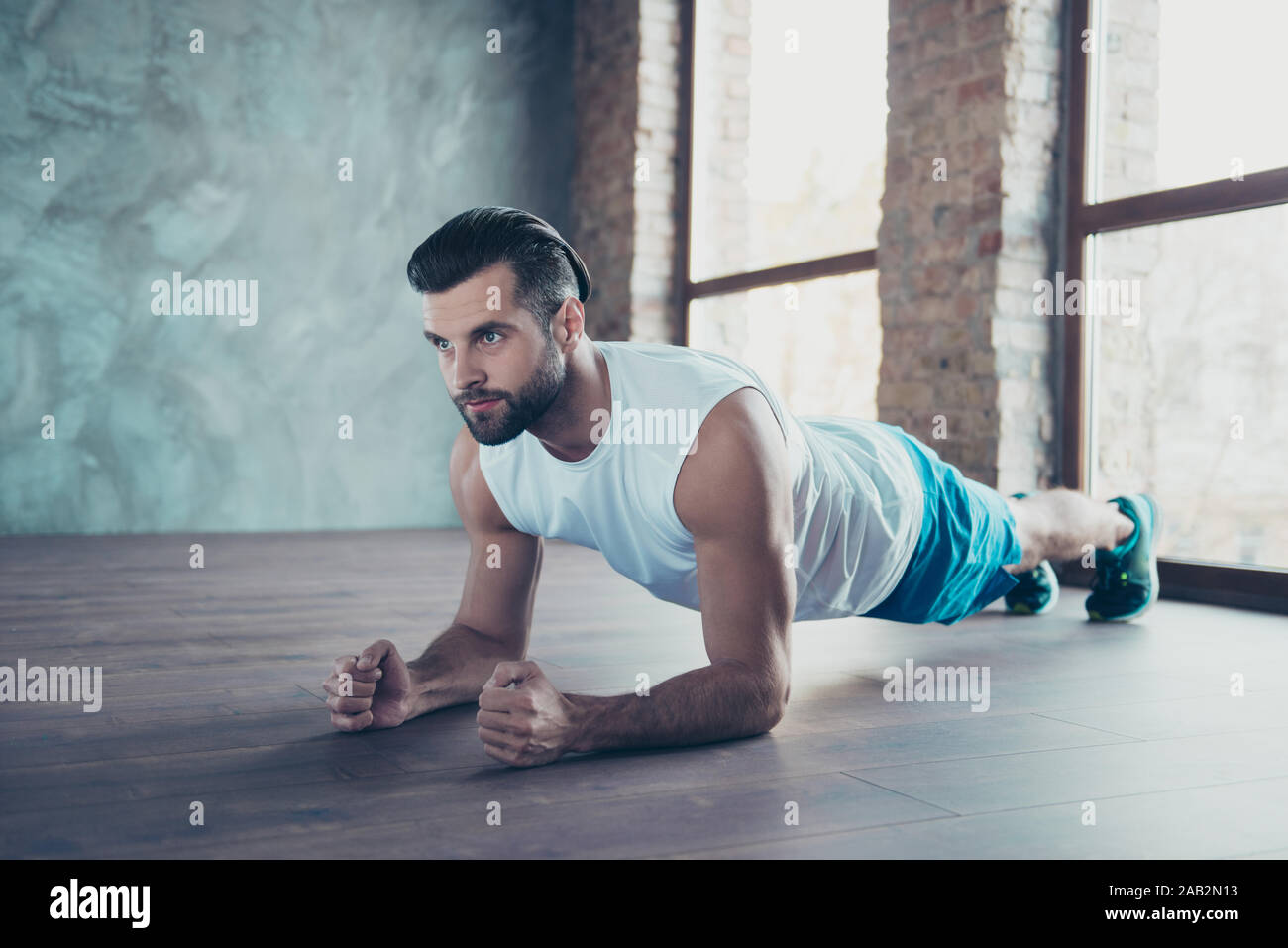 Profile photo of macho sportsman guy doing plank on elbows hands ...