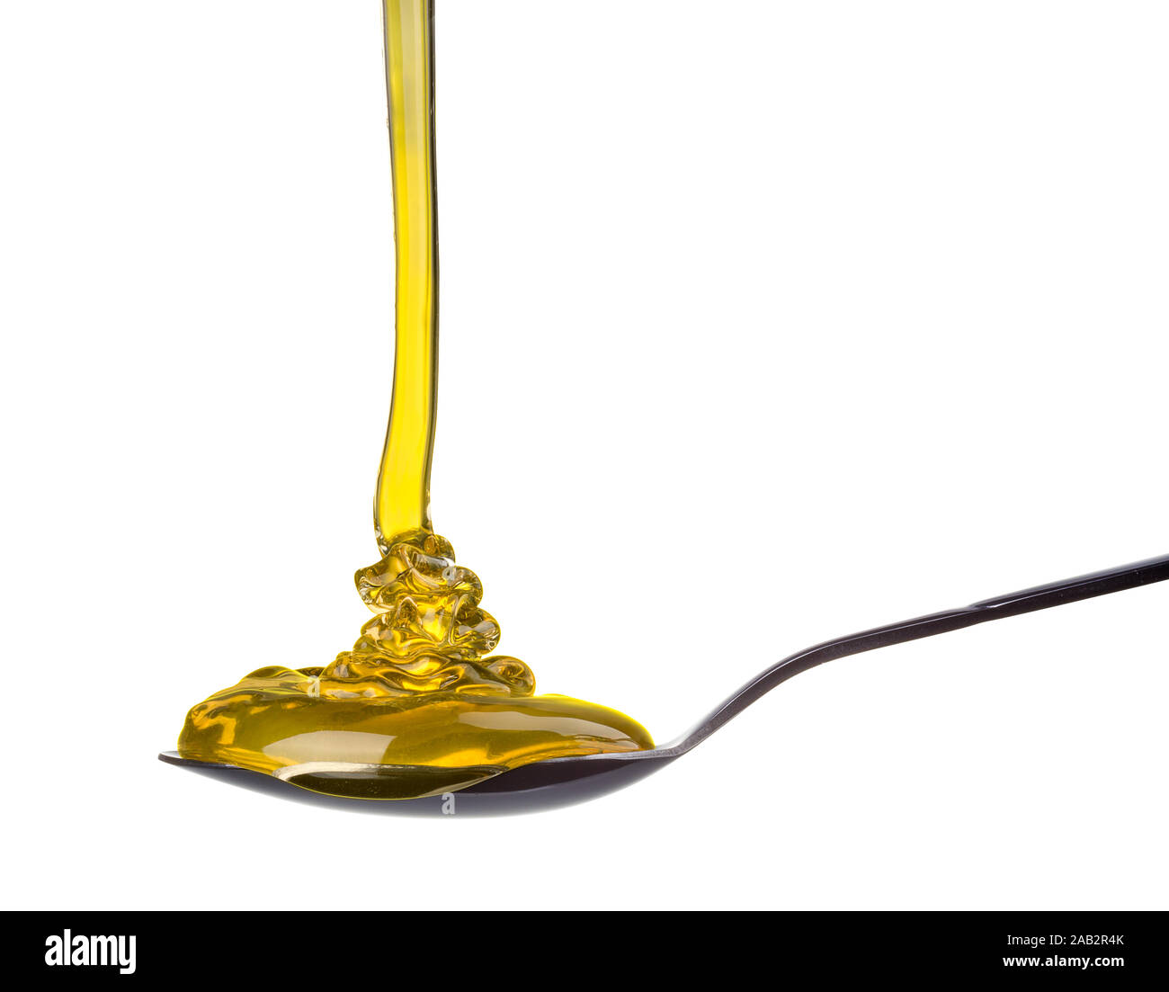 Falling and flowing honey on a spoon isolated on white with clipping ...