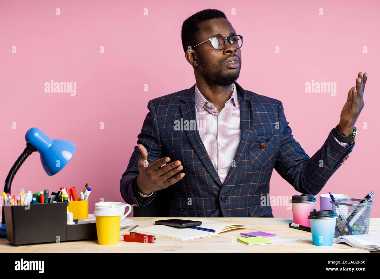 Angry confused dark skinned man owner of company, gesturing angrily and ...