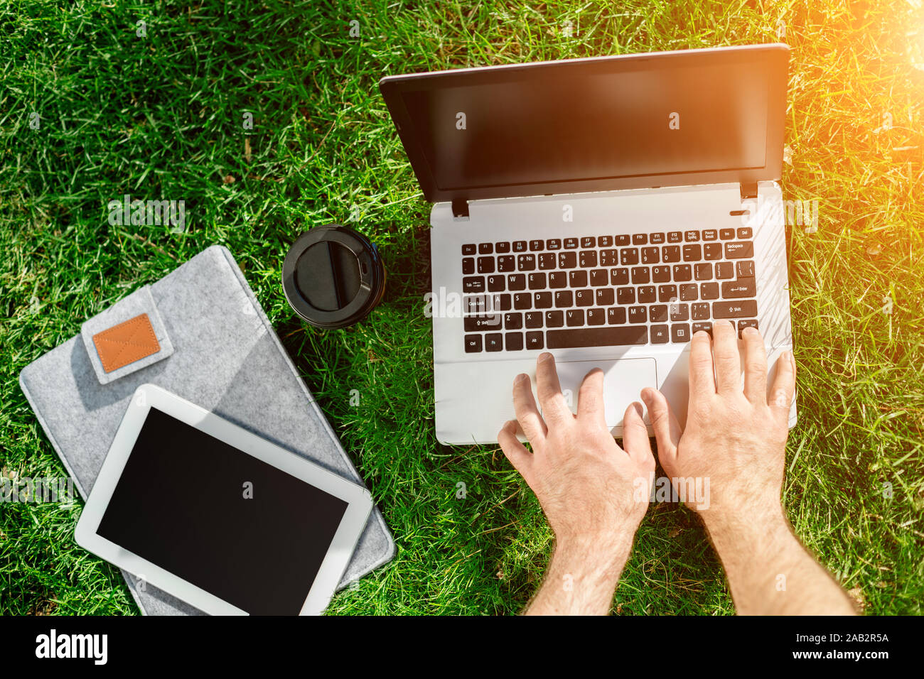 Close-up shot of handsome man's hands touching laptop computer's screen ...