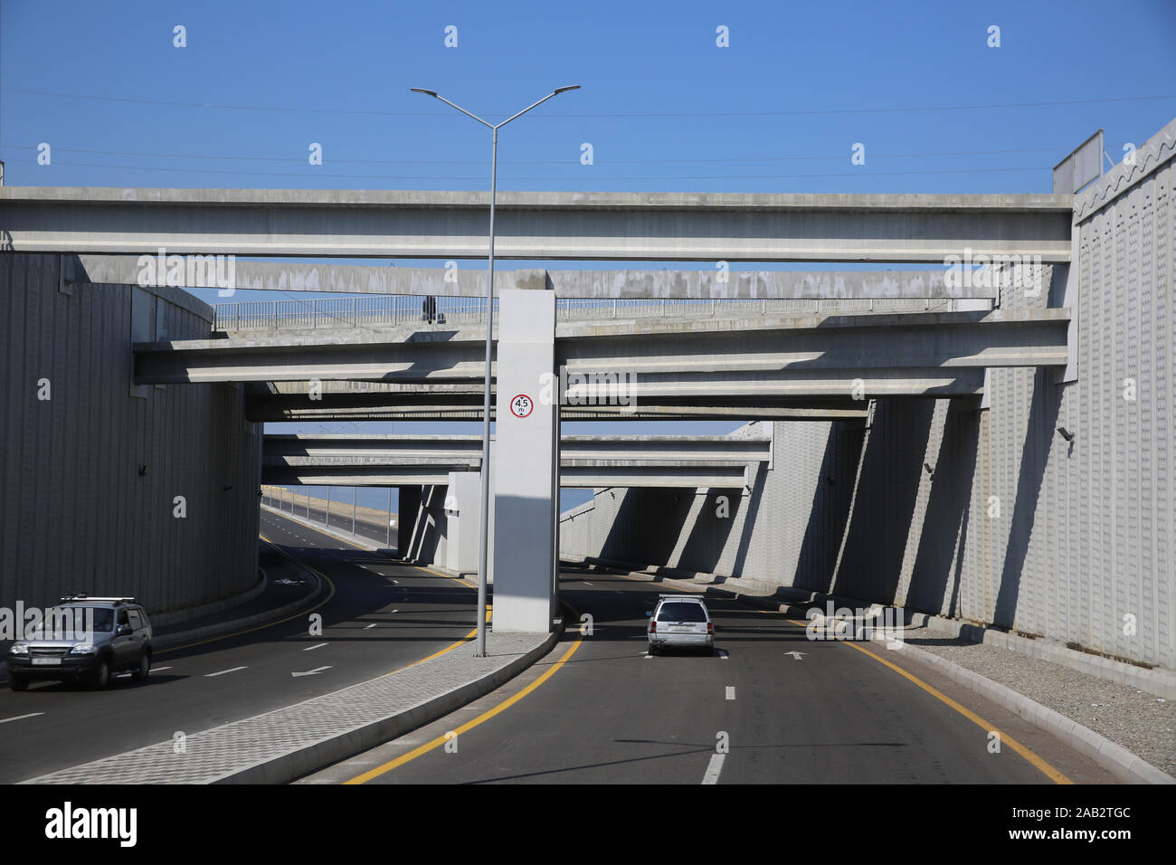 Concrete narrow underground tunnel for cars. Under the bridge is a ...